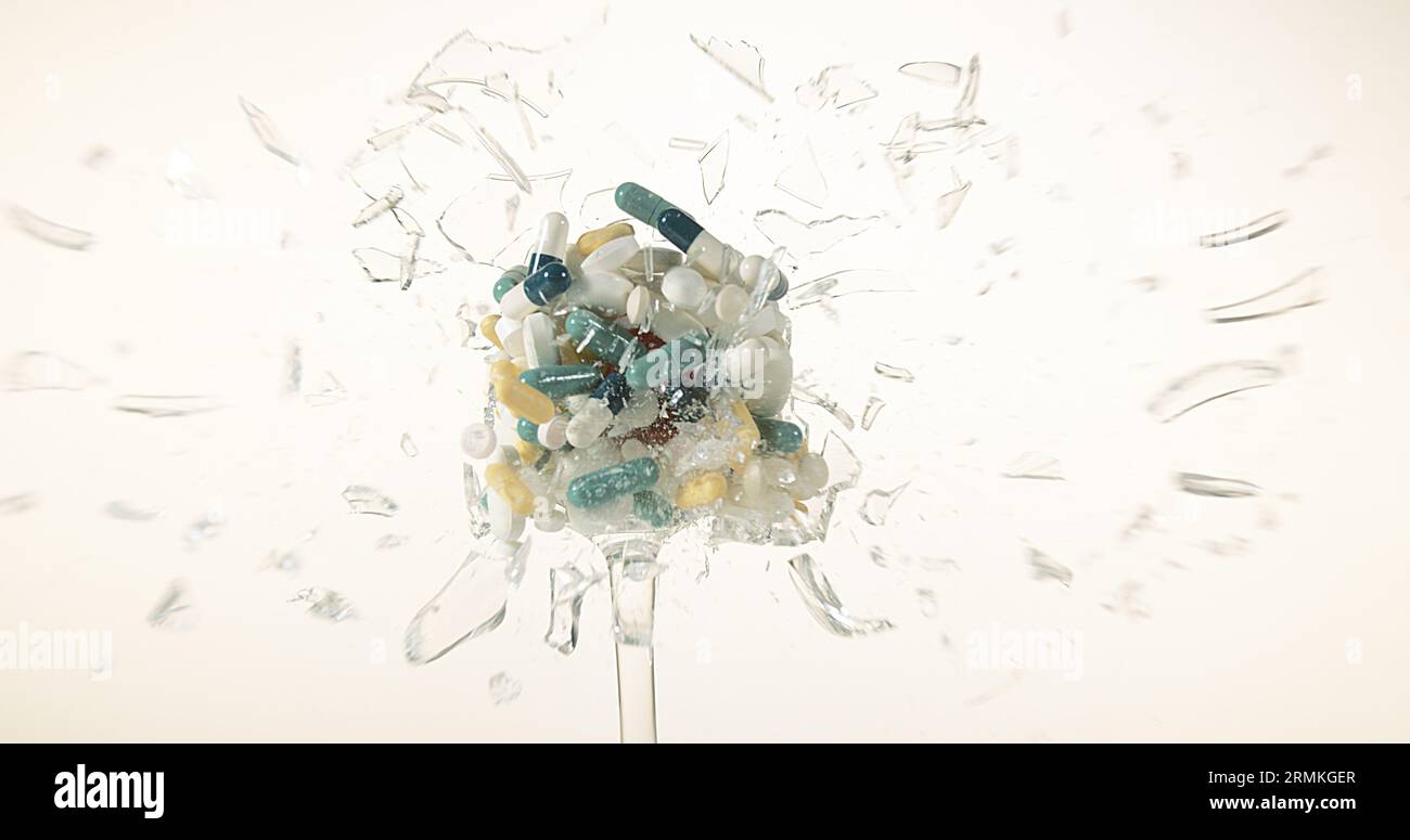 Glass filled with Capsules Exploding against White Background Stock ...