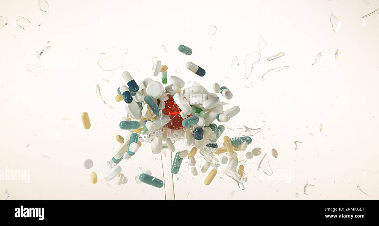 Glass filled with Capsules Exploding against White Background Stock ...