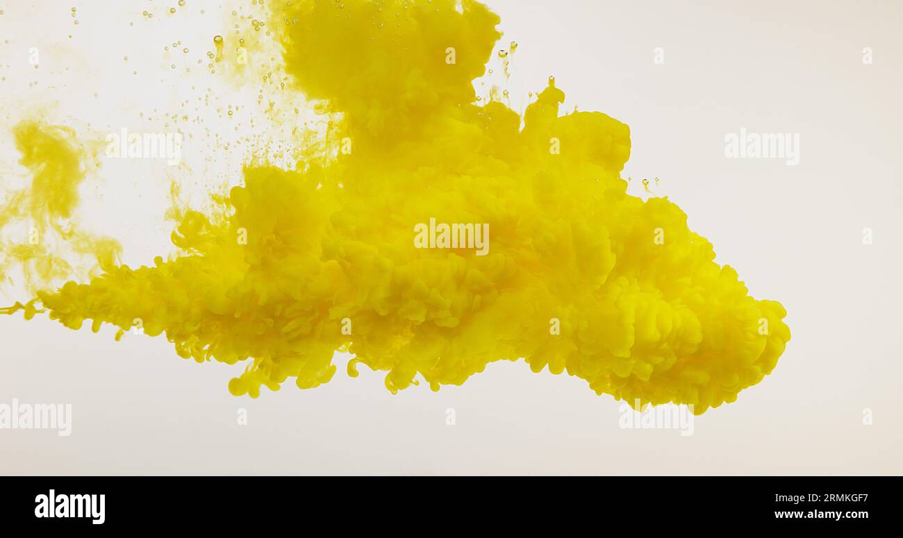 Yellow Ink entering Water against white Background Stock Photo - Alamy