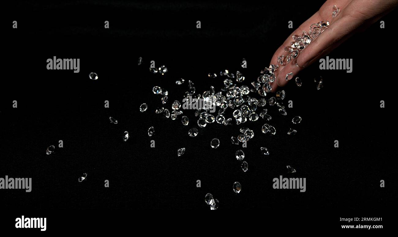 Hand of Woman with Diamonds against Black Background Stock Photo - Alamy