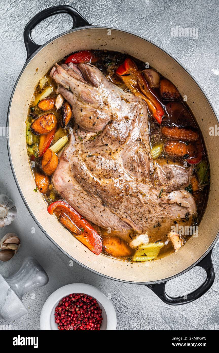 Braised lamb mutton shoulder in a baking dish with vegetables in red ...