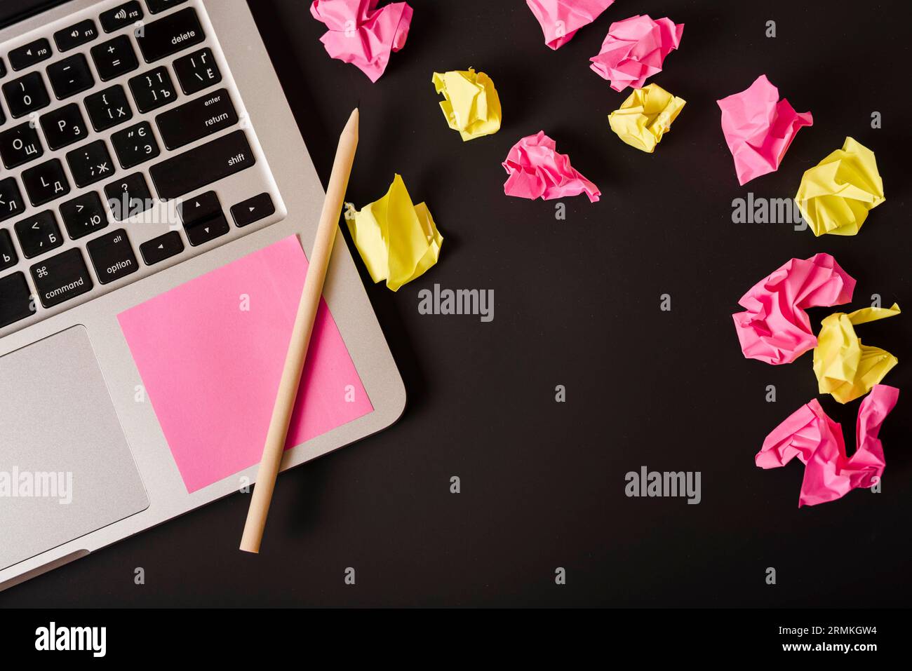 Ball crumpled papers with adhesive note pencil laptop against black ...