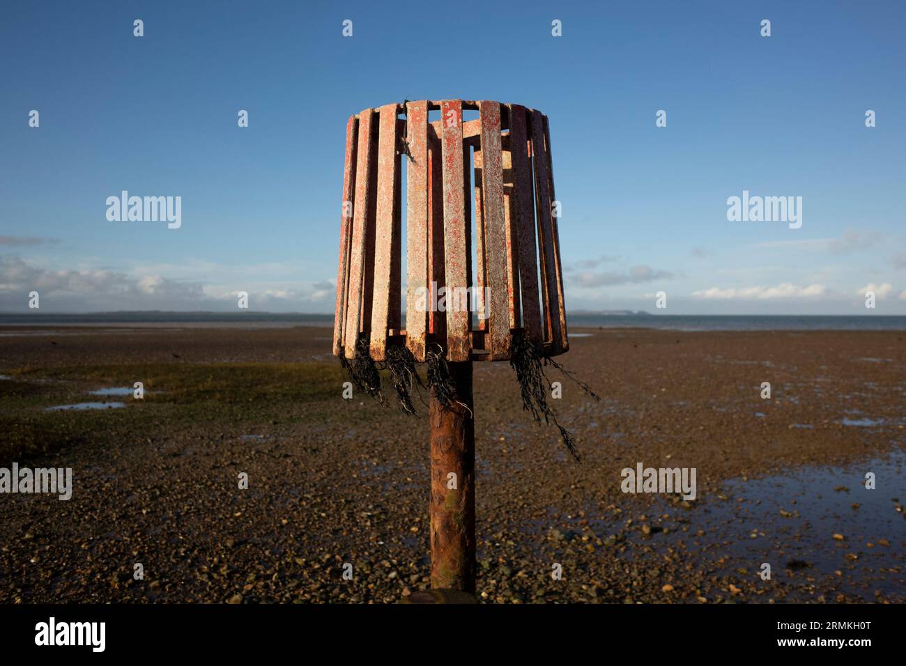 Faded red high tide maker on a beach in Whitstable Kent UK Stock Photo ...