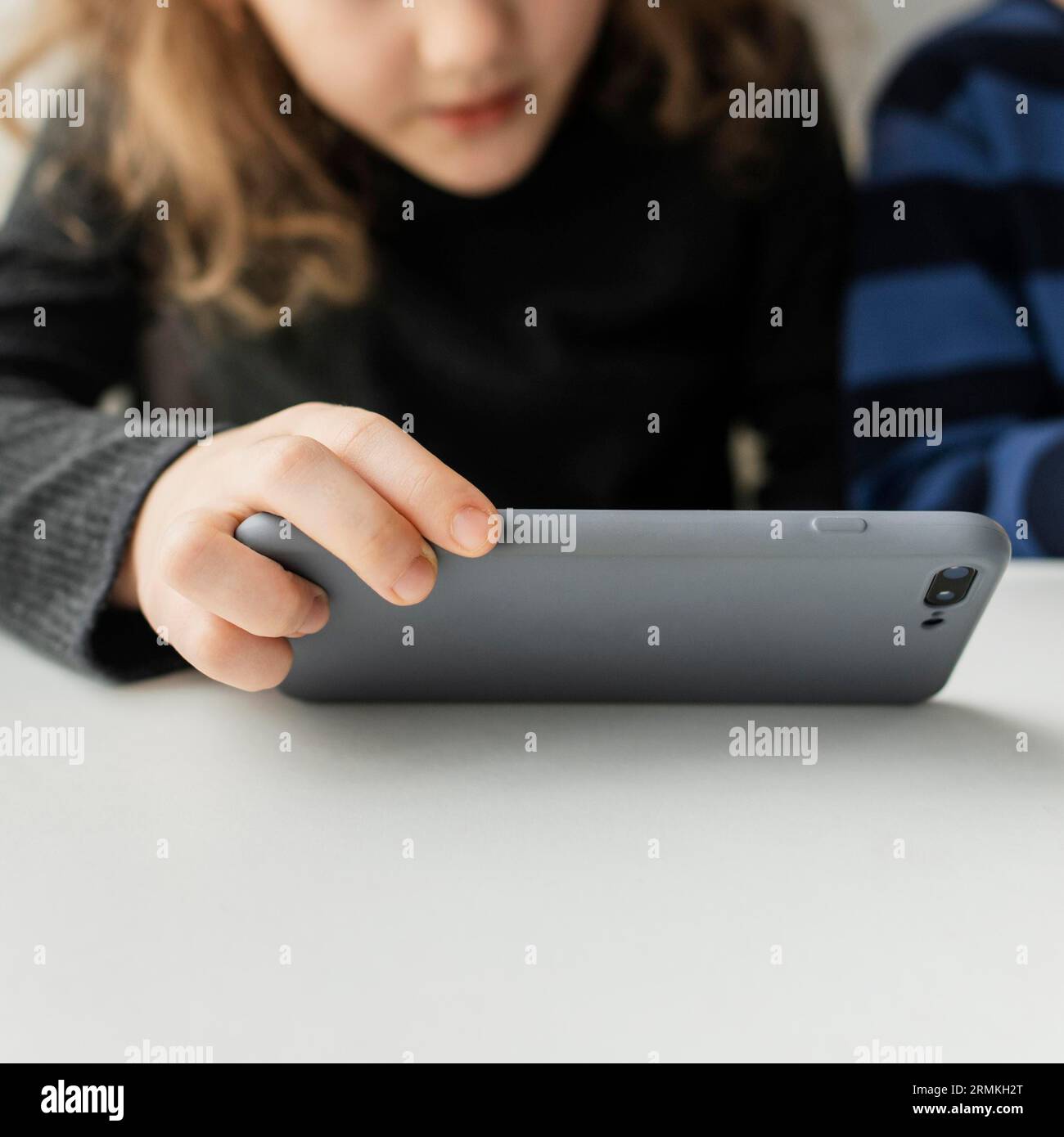 Close up kid holding phone Stock Photo - Alamy