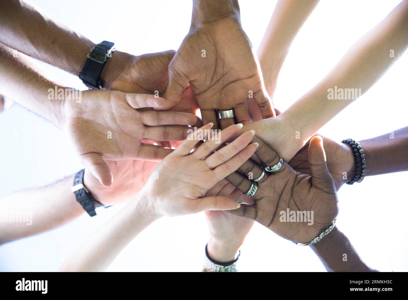 Bottom view people putting hands together Stock Photo - Alamy