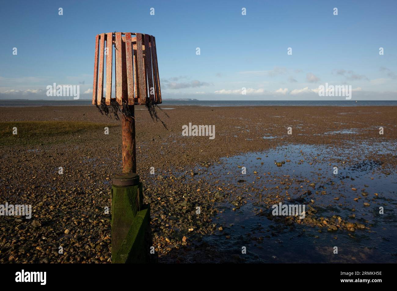 Faded red high tide maker on a beach in Whitstable Kent UK Stock Photo ...