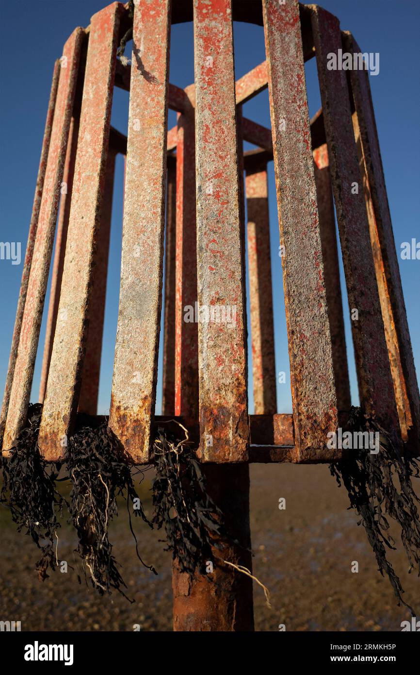 Faded red high tide maker on a beach in Whitstable Kent UK Stock Photo ...