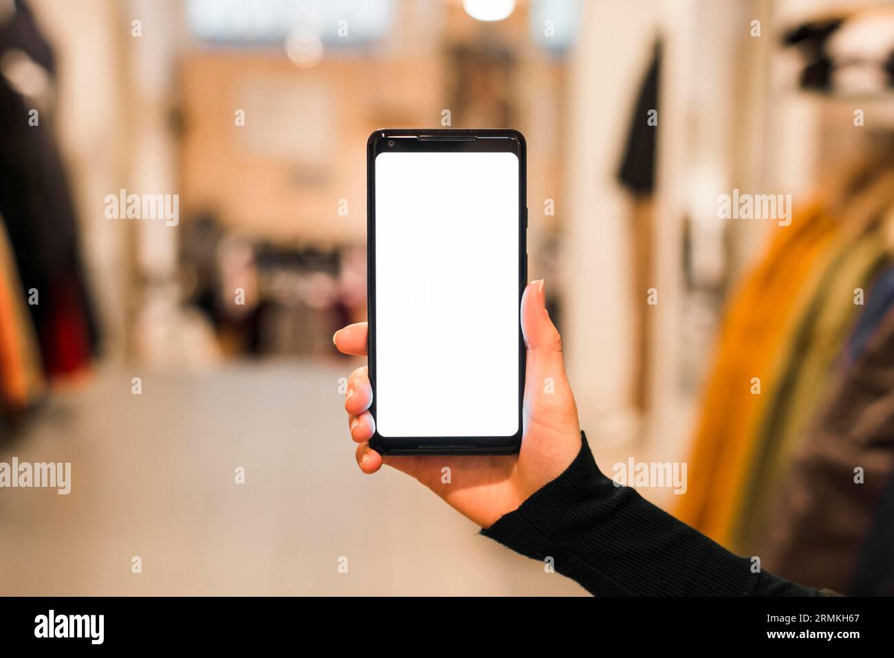 Close up woman s hand showing her smart phone with white screen display ...