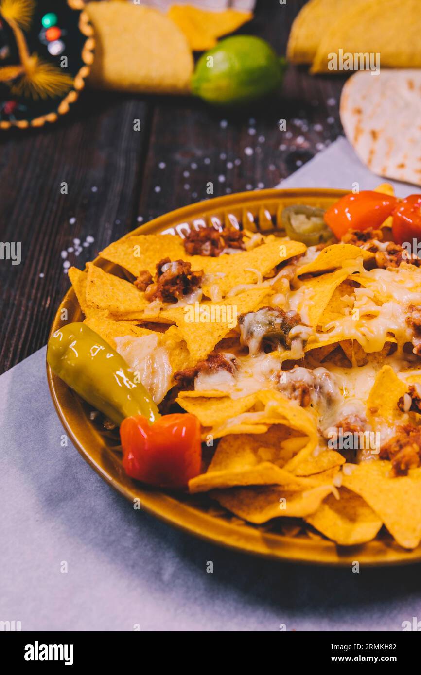 Close up yellow mexican nachos plate butter paper Stock Photo - Alamy