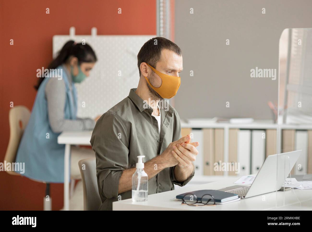 Employee disinfecting hands work Stock Photo - Alamy