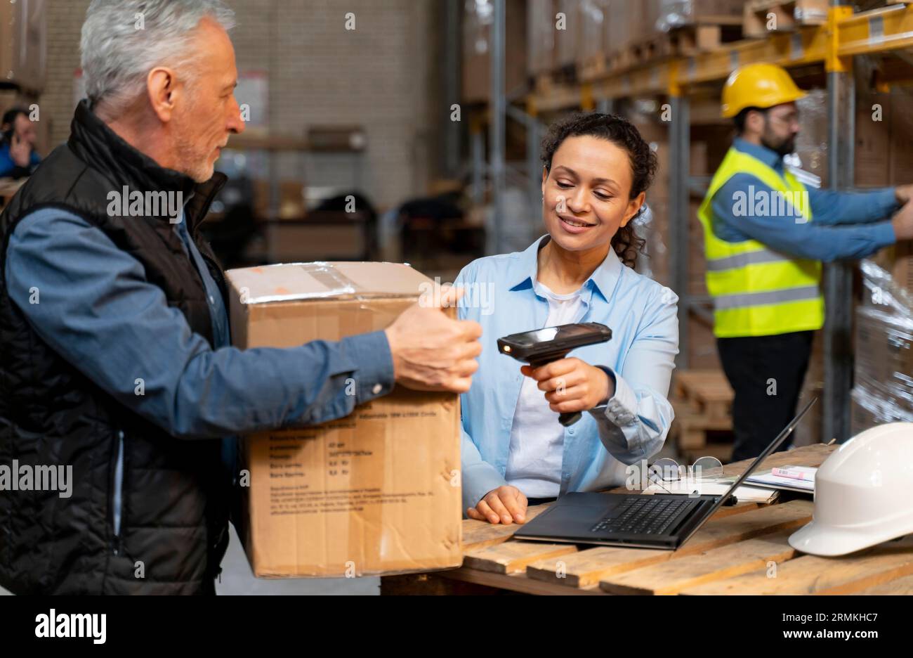 Employees working warehouse Stock Photo - Alamy