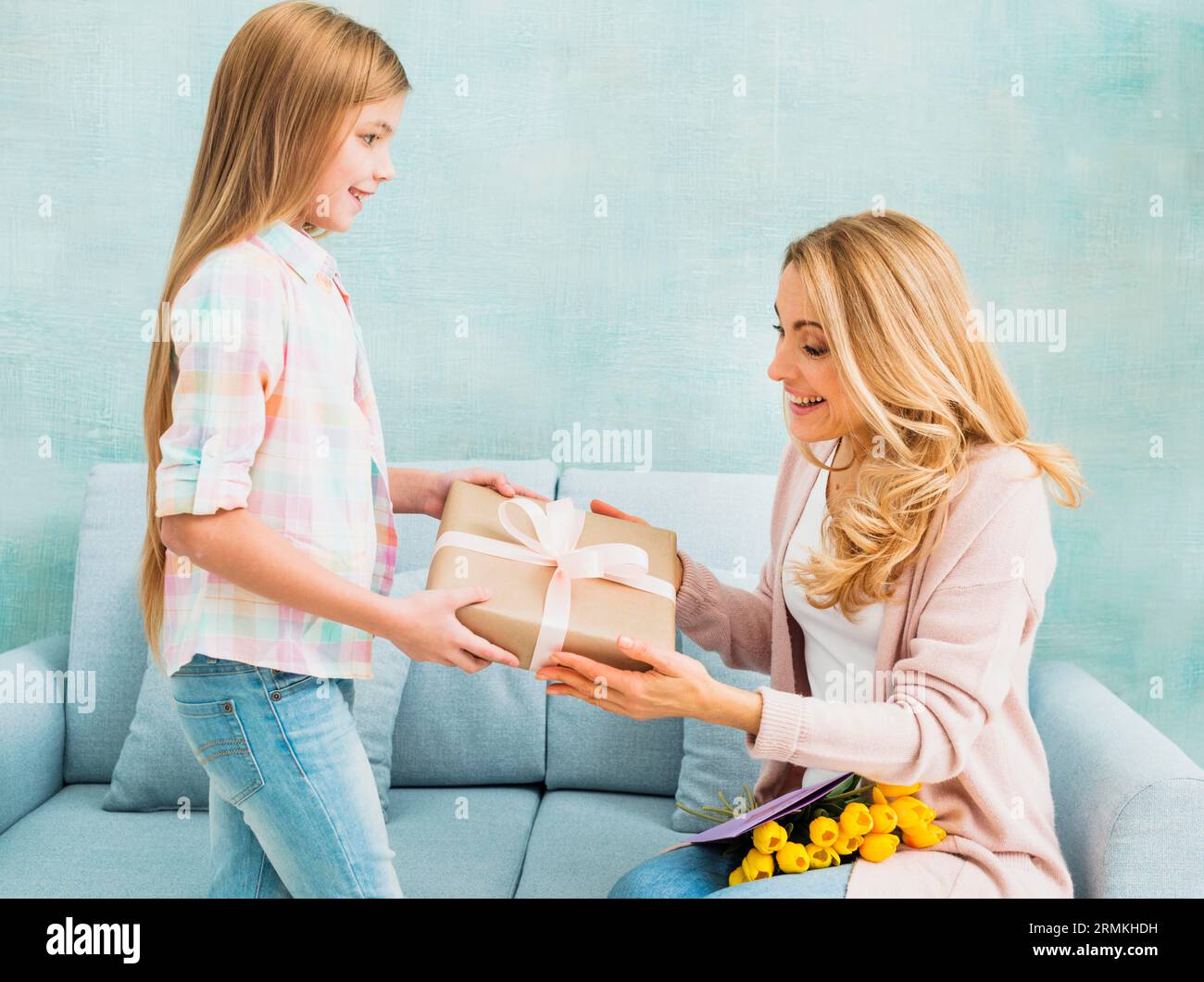 Daughter giving gift box mother Stock Photo - Alamy