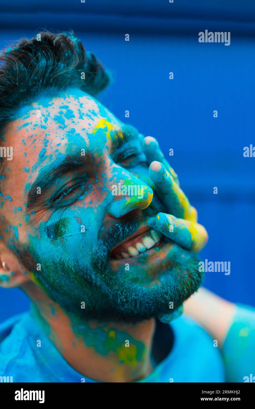 Face man stained blue powder holi festival Stock Photo - Alamy