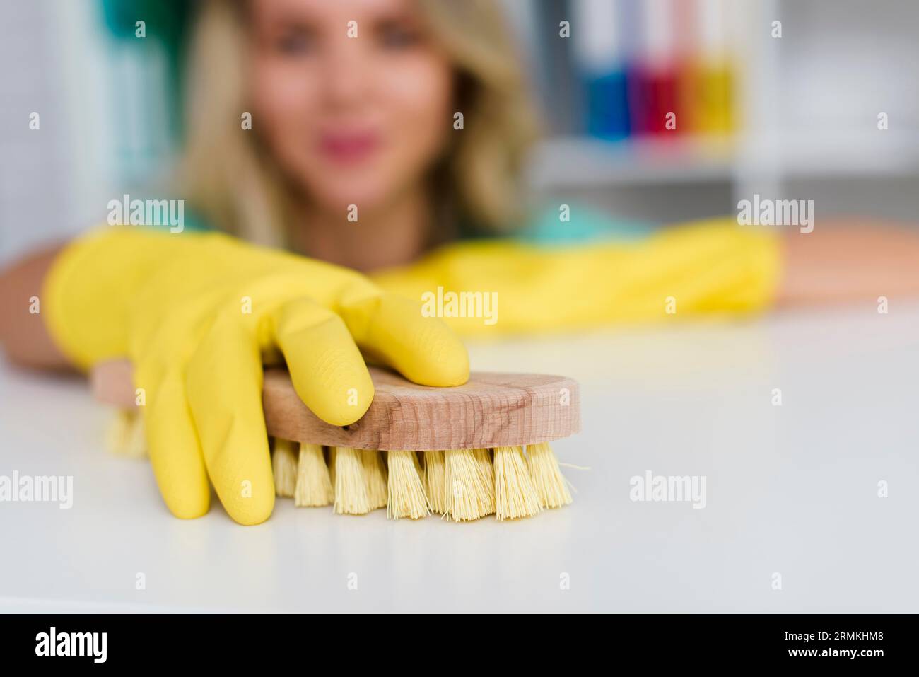 Female hand cleaning white desk with wooden brush Stock Photo - Alamy