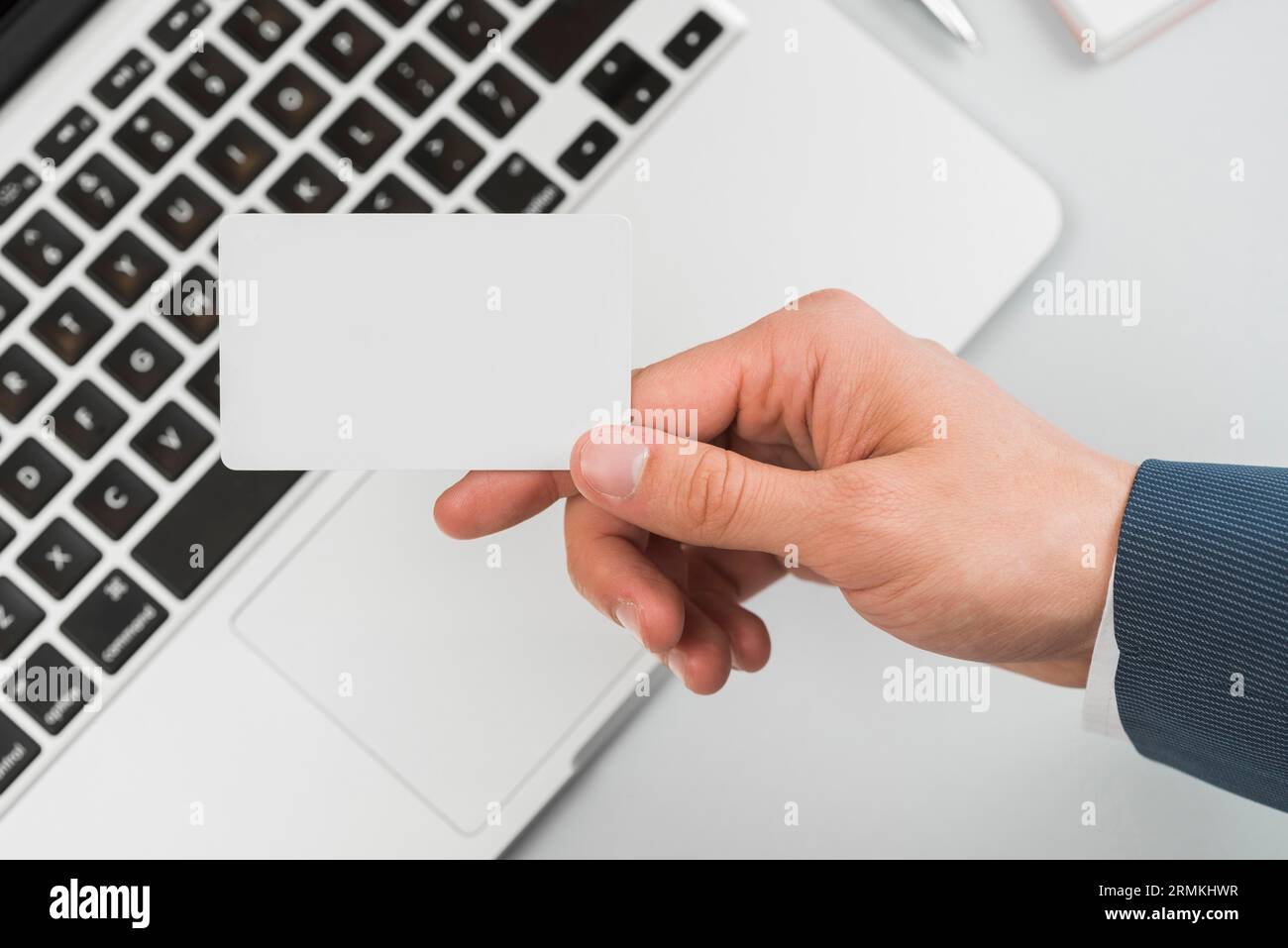 Hand holding business card office environment Stock Photo - Alamy
