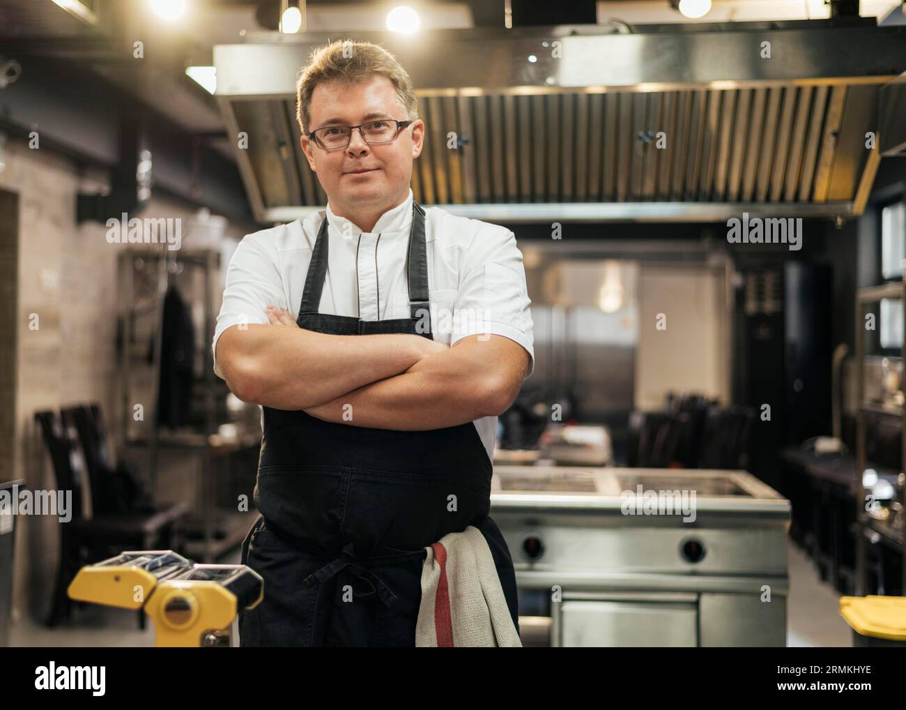 Front view male chef posing with arms crossed kitchen Stock Photo - Alamy