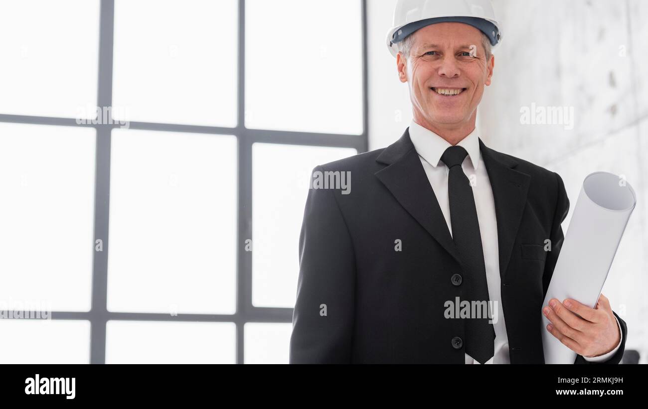 Low angle engineer male with plans Stock Photo - Alamy