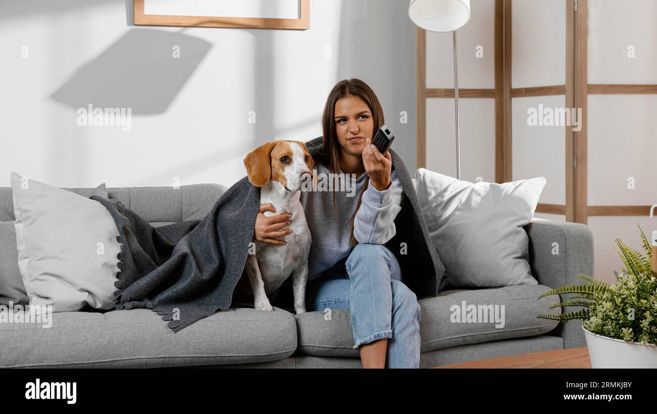 Medium shot girl dog watching tv Stock Photo - Alamy