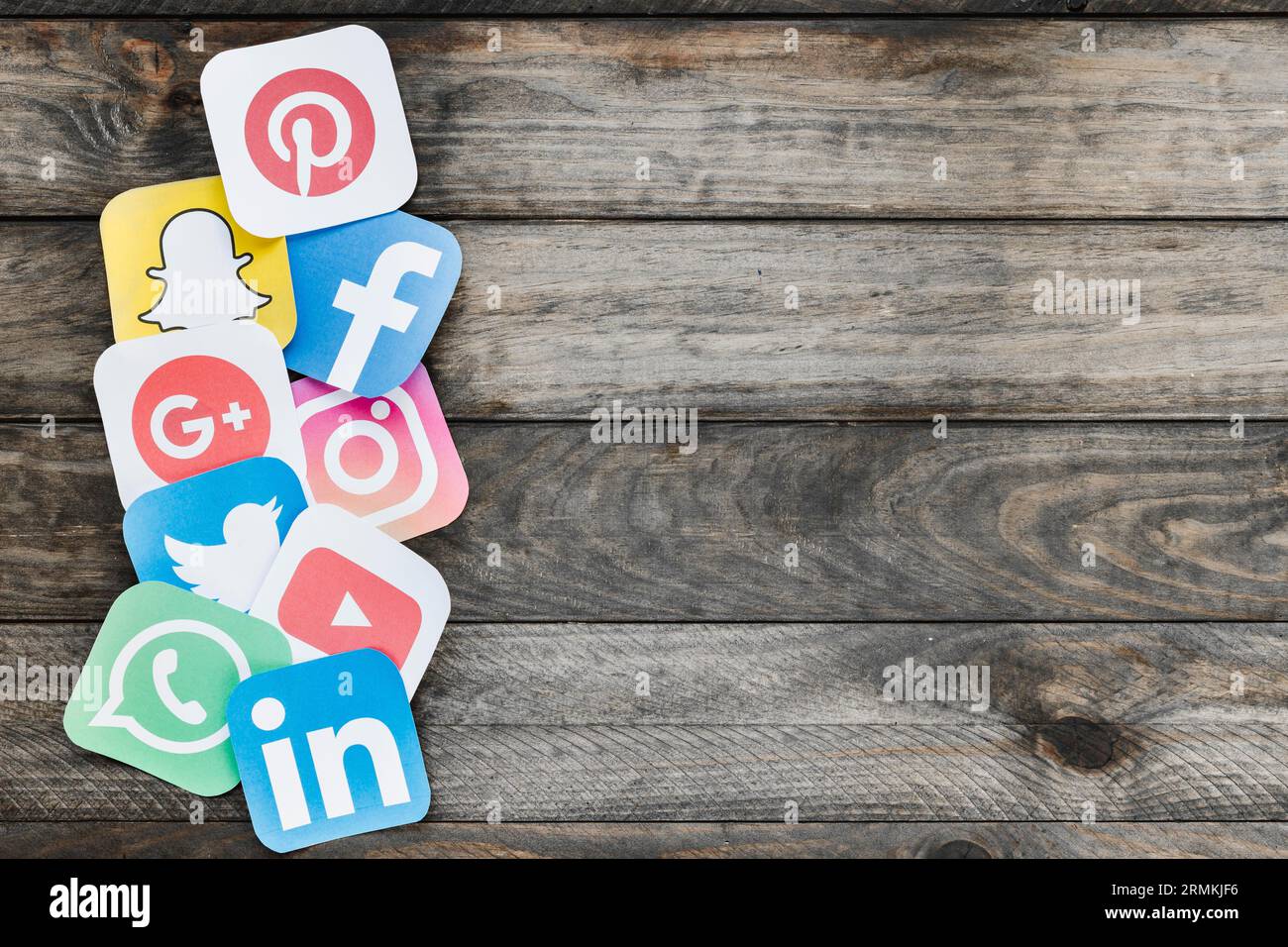 Paper cut outs applications icons old wooden background Stock Photo - Alamy