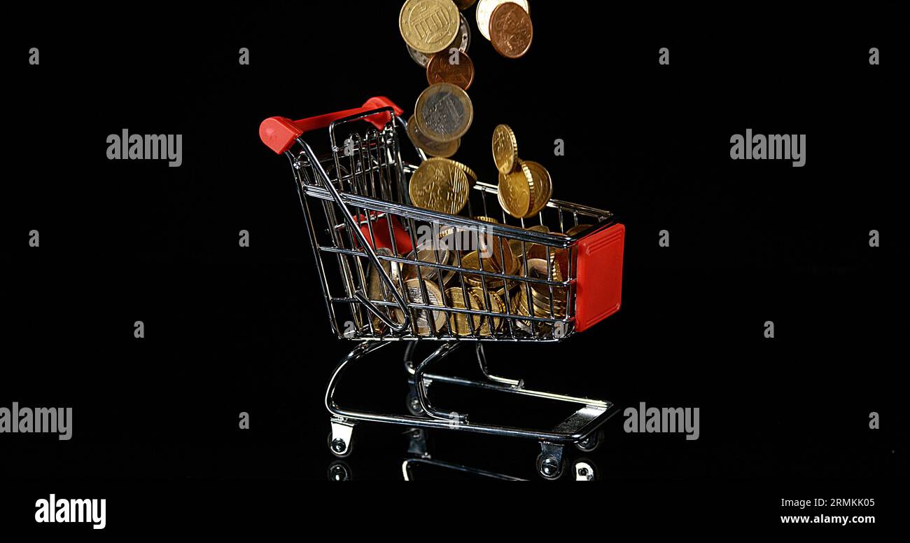 Euro Coins in Trolley rolling against Black Background Stock Photo - Alamy
