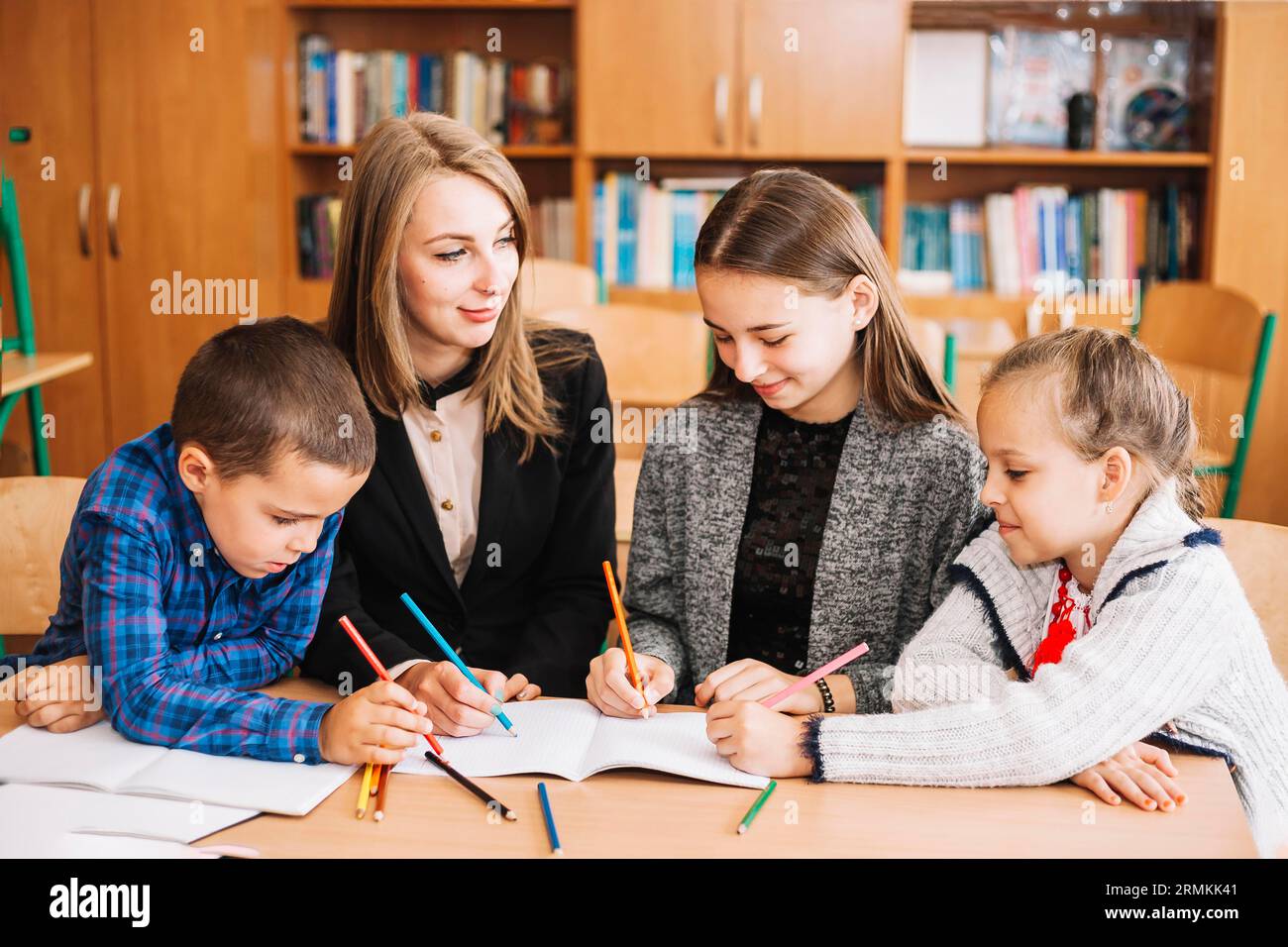 School teacher students coloring picture Stock Photo - Alamy