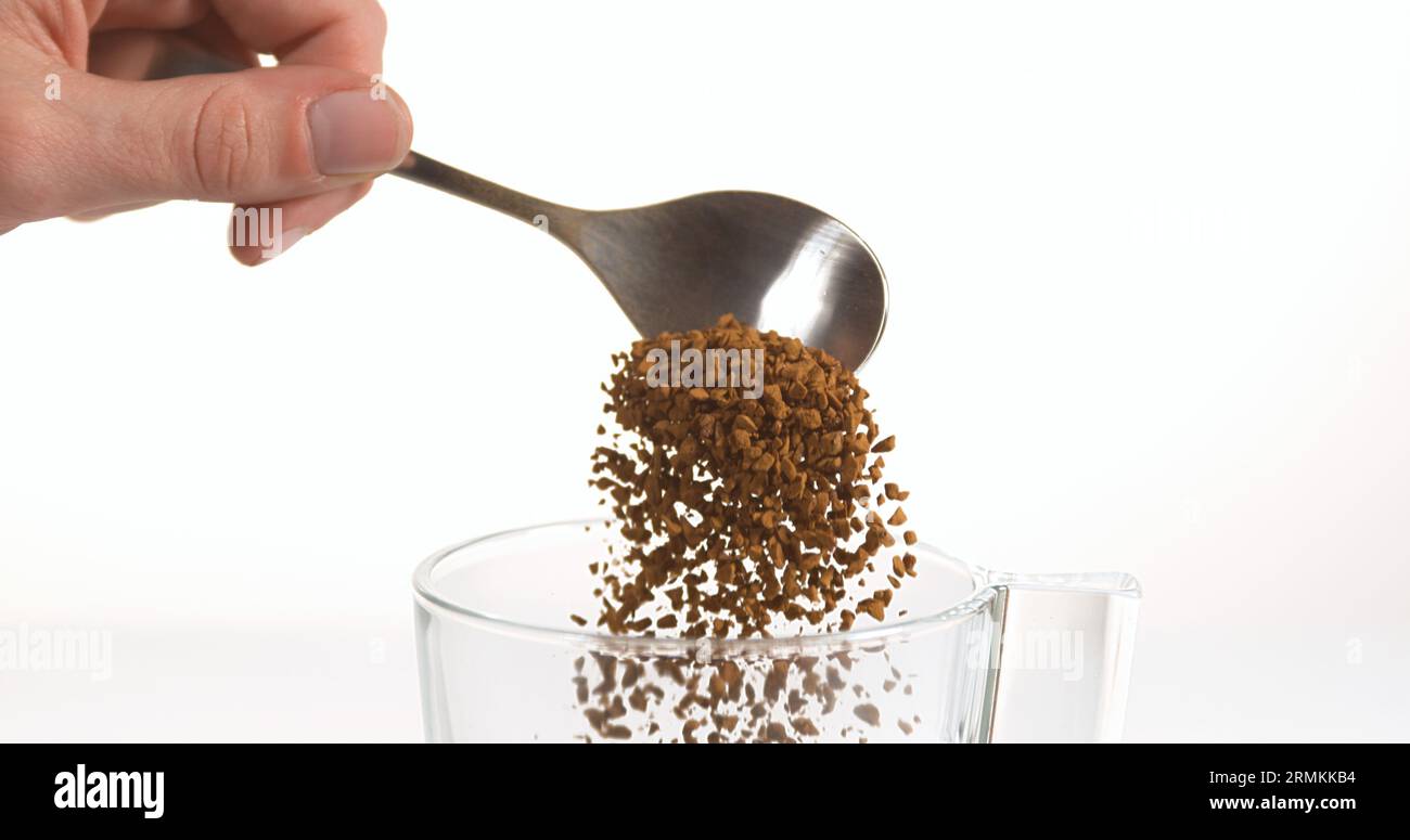 Instant Coffee Being Poured in a Cup against White Background Stock ...