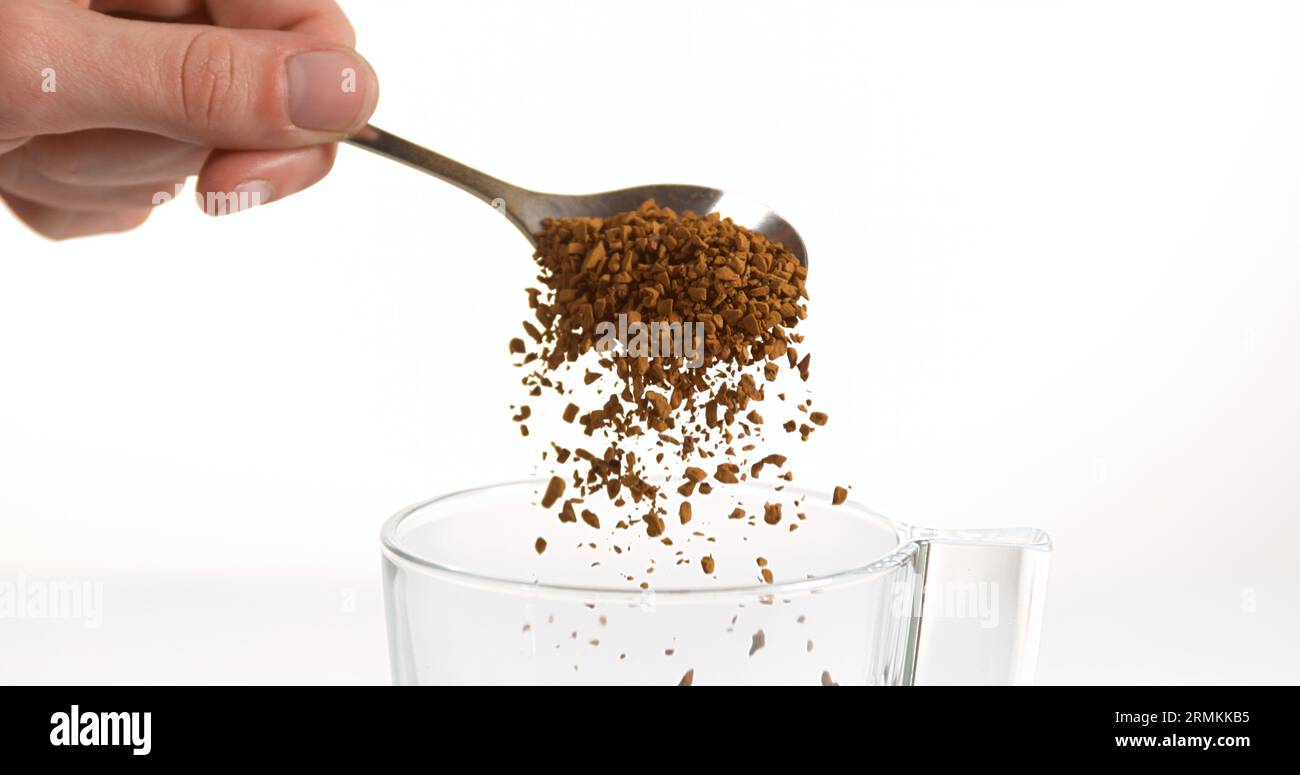 Instant Coffee Being Poured in a Cup against White Background Stock ...