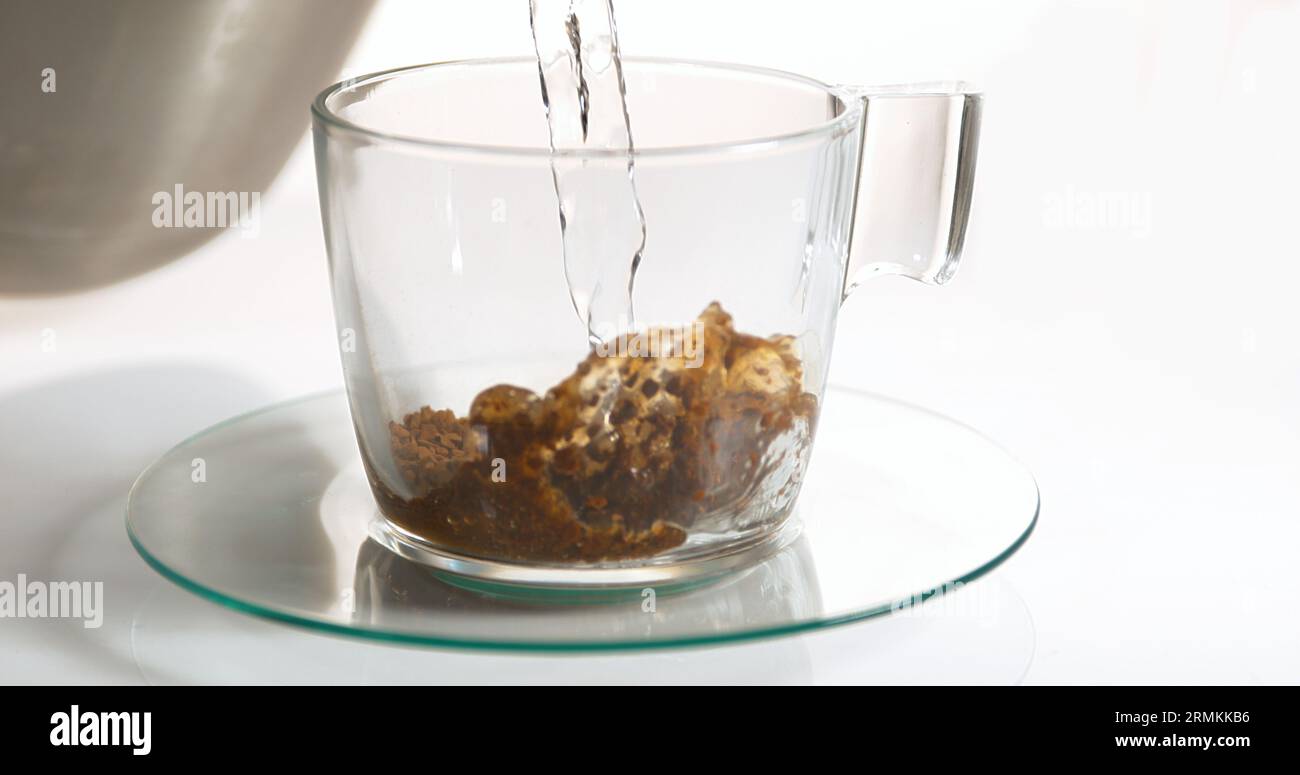 Instant Coffee Being Poured in a Cup against White Background Stock ...
