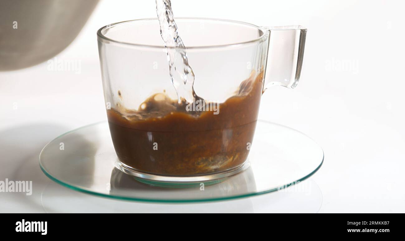 Instant Coffee Being Poured in a Cup against White Background Stock ...