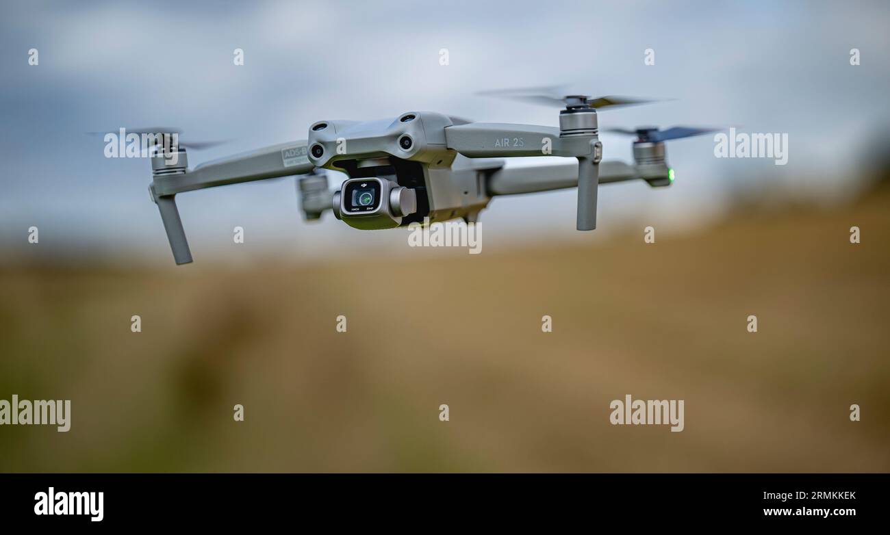 A DJI Air 2S Drone low to the ground as it hovers whist filming Stock ...