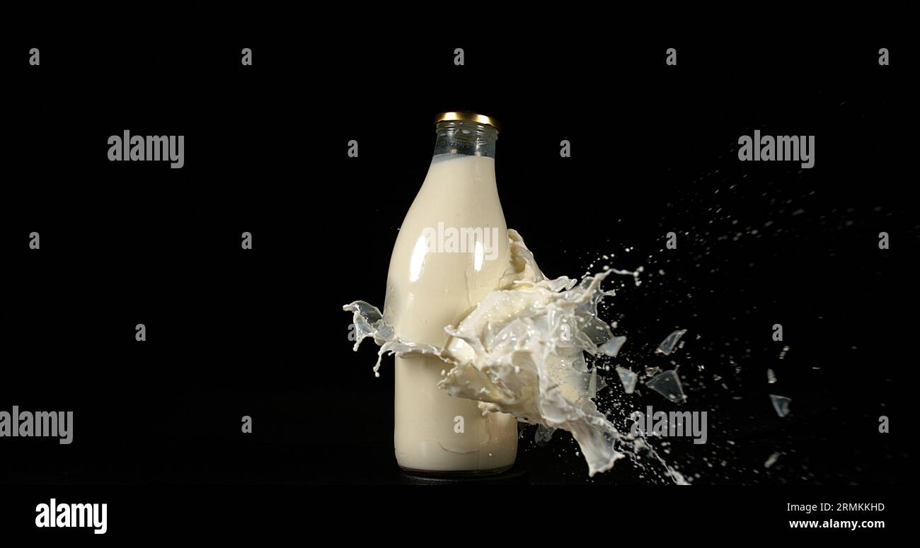 Bottle of Milk Exploding against Black Background Stock Photo - Alamy