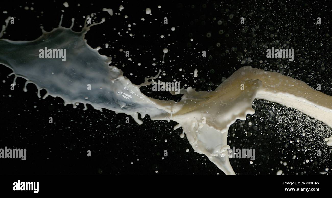Exploding Milk against Black Background Stock Photo - Alamy