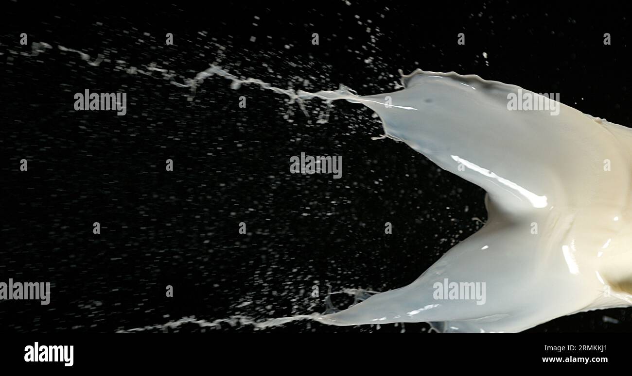 Exploding Milk against Black Background Stock Photo - Alamy
