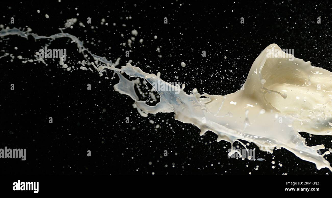 Exploding Milk against Black Background Stock Photo - Alamy