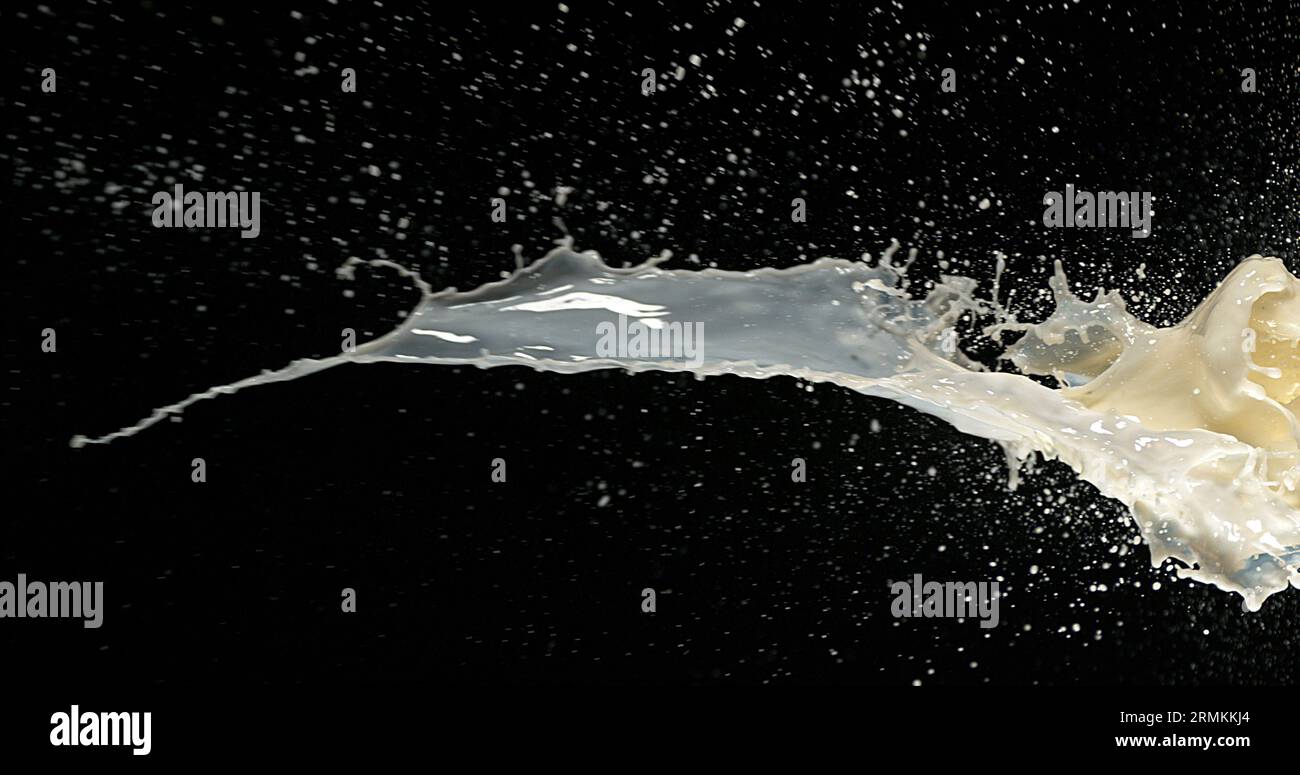 Exploding Milk against Black Background Stock Photo - Alamy
