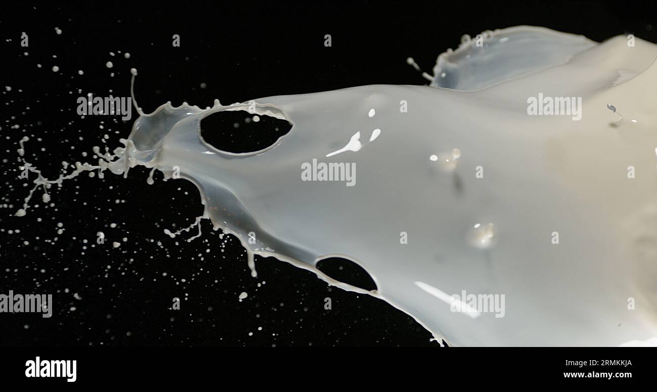 Exploding Milk against Black Background Stock Photo - Alamy