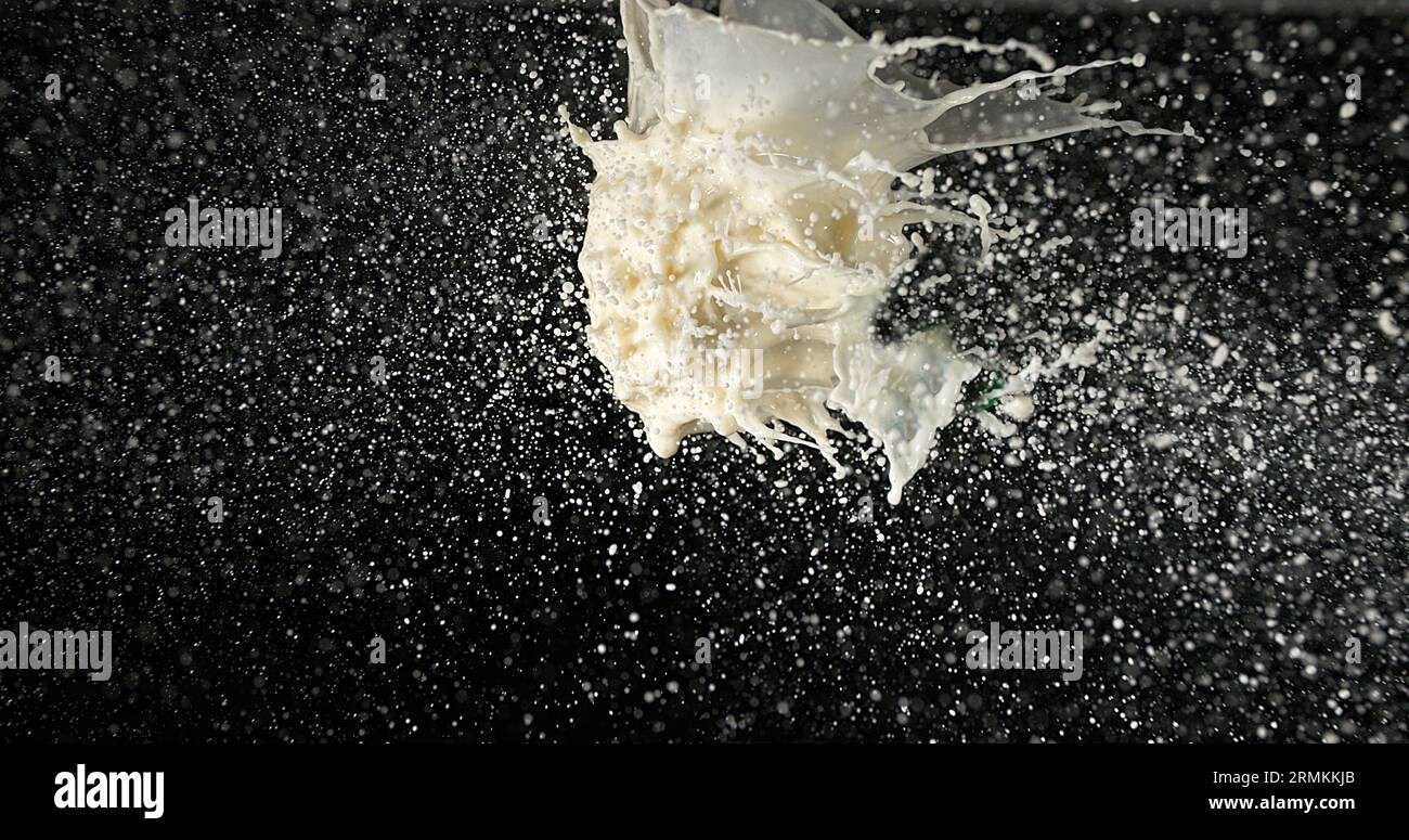 Exploding Milk against Black Background Stock Photo - Alamy