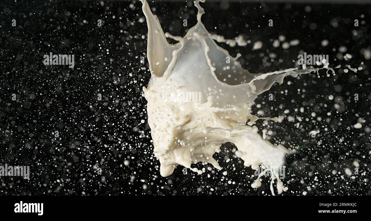 Exploding Milk against Black Background Stock Photo - Alamy