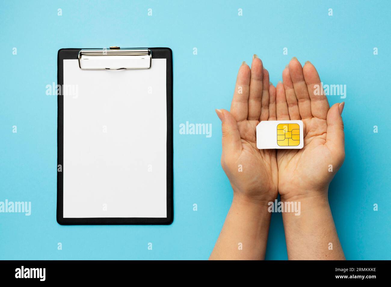 Top view hand holding sim card with clipboard Stock Photo - Alamy