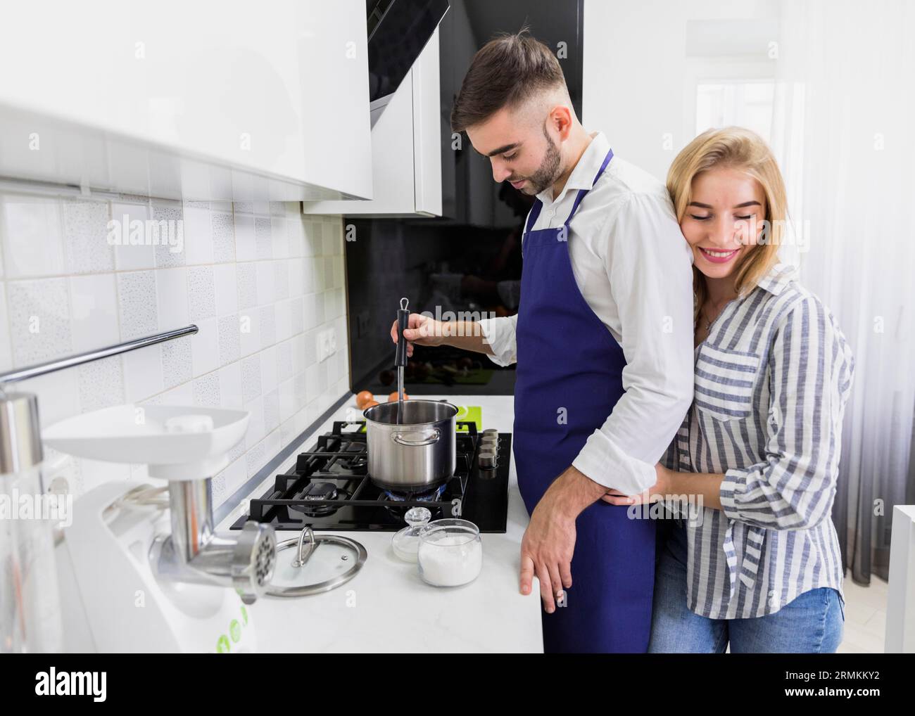 Young couple boiling water pot Stock Photo - Alamy