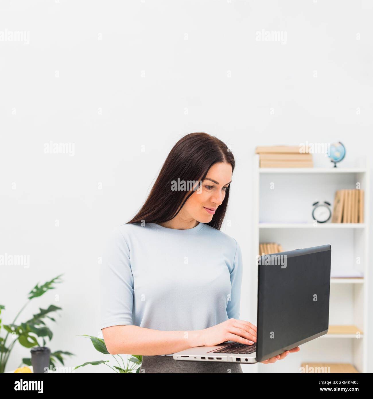 Woman blue typing laptop keyboard Stock Photo - Alamy