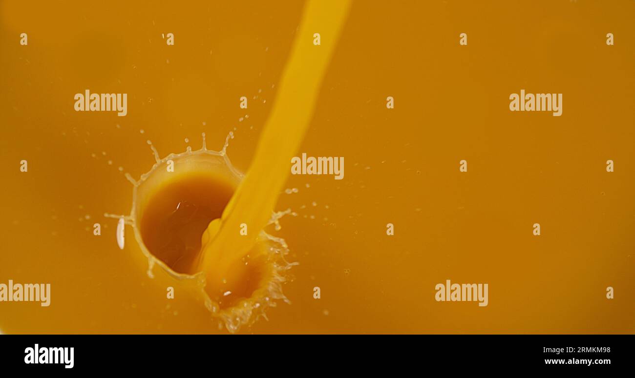 Orange Juice being poured Stock Photo - Alamy