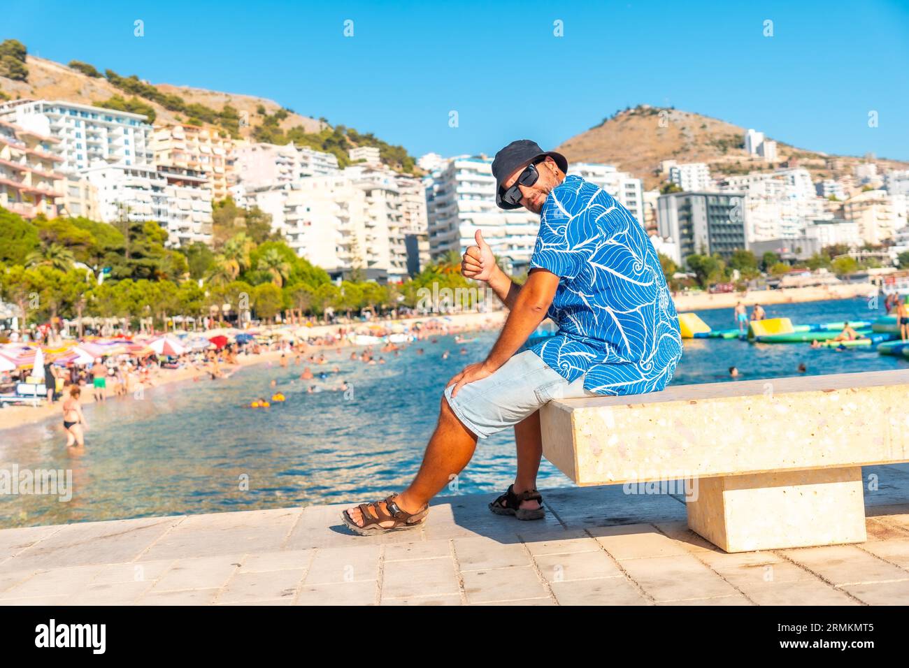 Tourist on vacation sitting by the sea at Saranda Beach on the Albanian ...