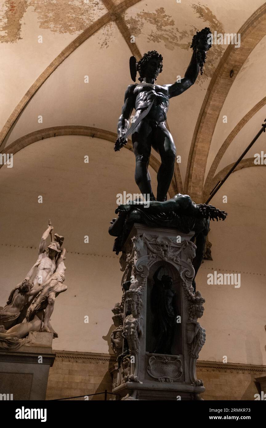 Under the illuminated light is one of the statues of Perseus with the ...