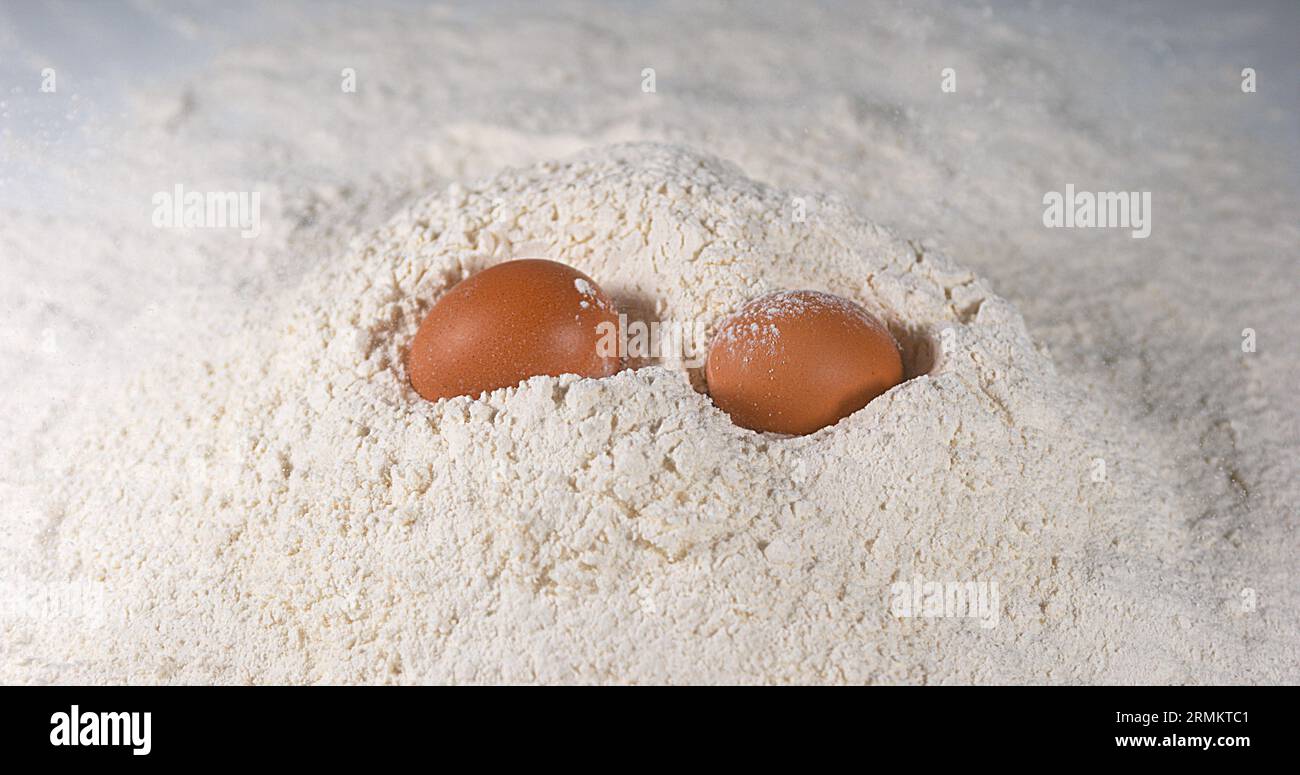 Egg Falling into Flour against White Background Stock Photo - Alamy