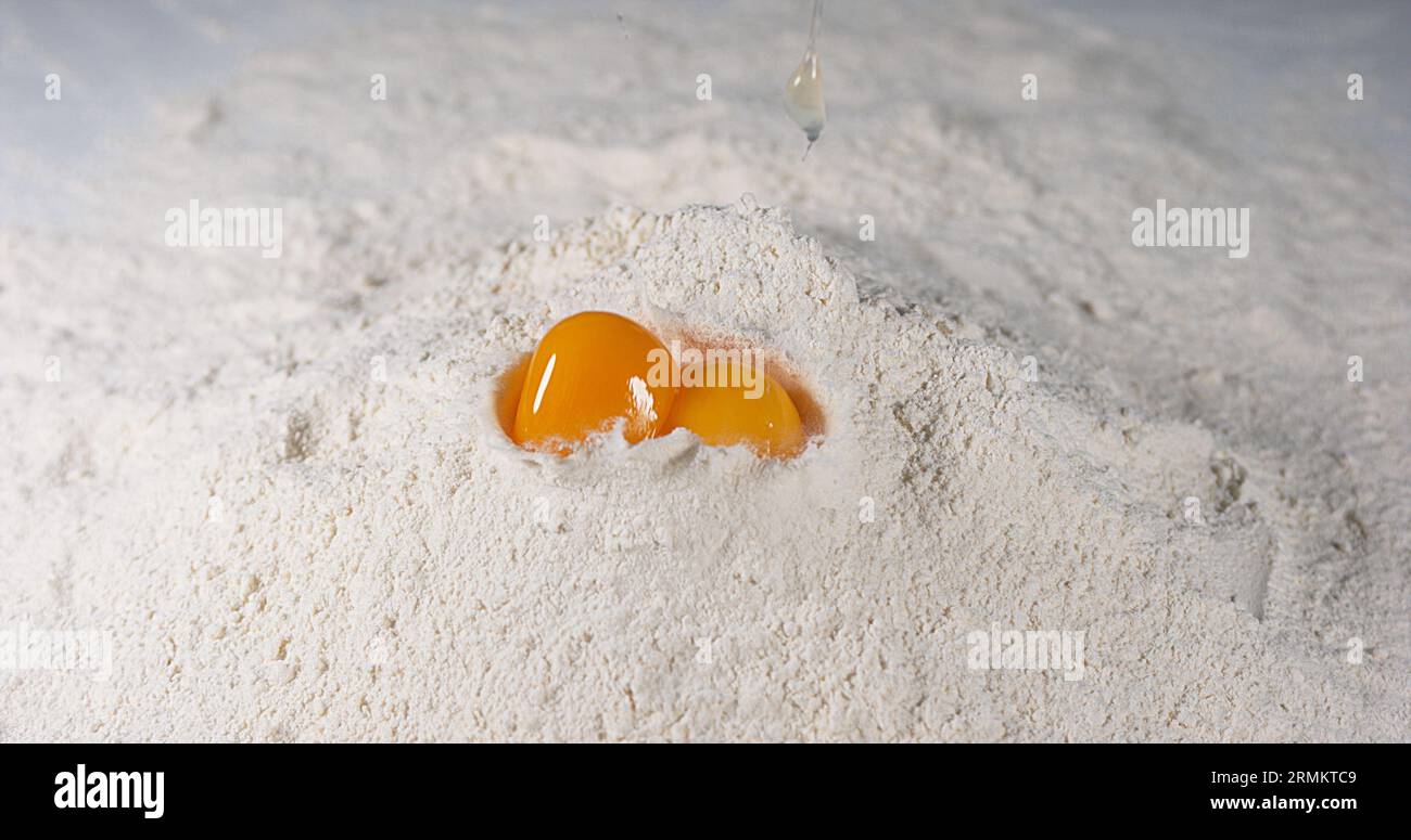 Egg Falling into Flour against White Background Stock Photo - Alamy