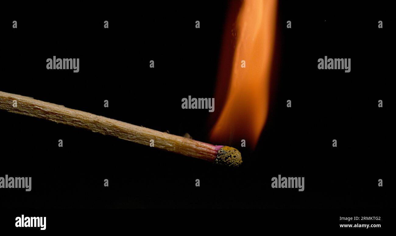 Igniting Match against Black background Stock Photo - Alamy