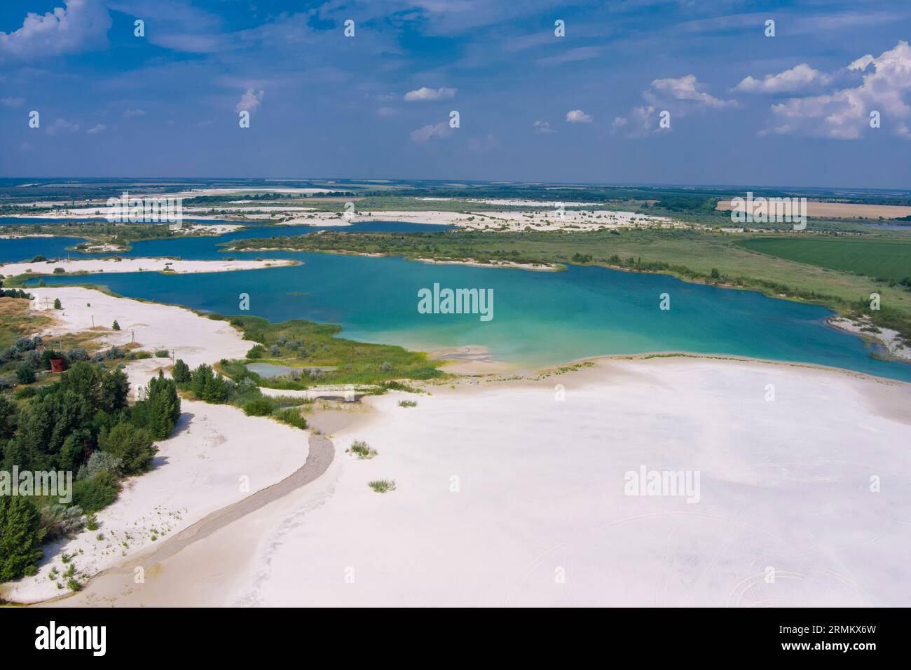 Top view of flooded quarries with white quartz sand. Beautiful ...