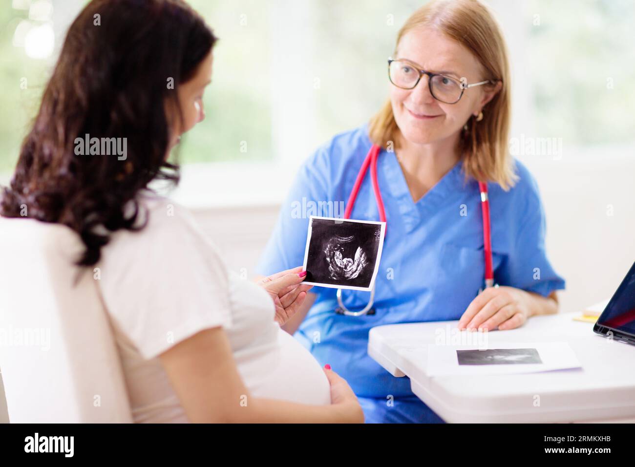 Doctor examining pregnant woman. Pregnancy check. Young Asian female at ...