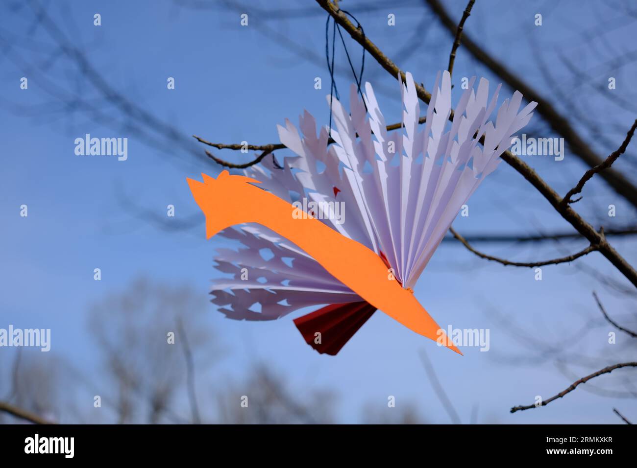 Orange paper bird on a tree, origami Stock Photo - Alamy